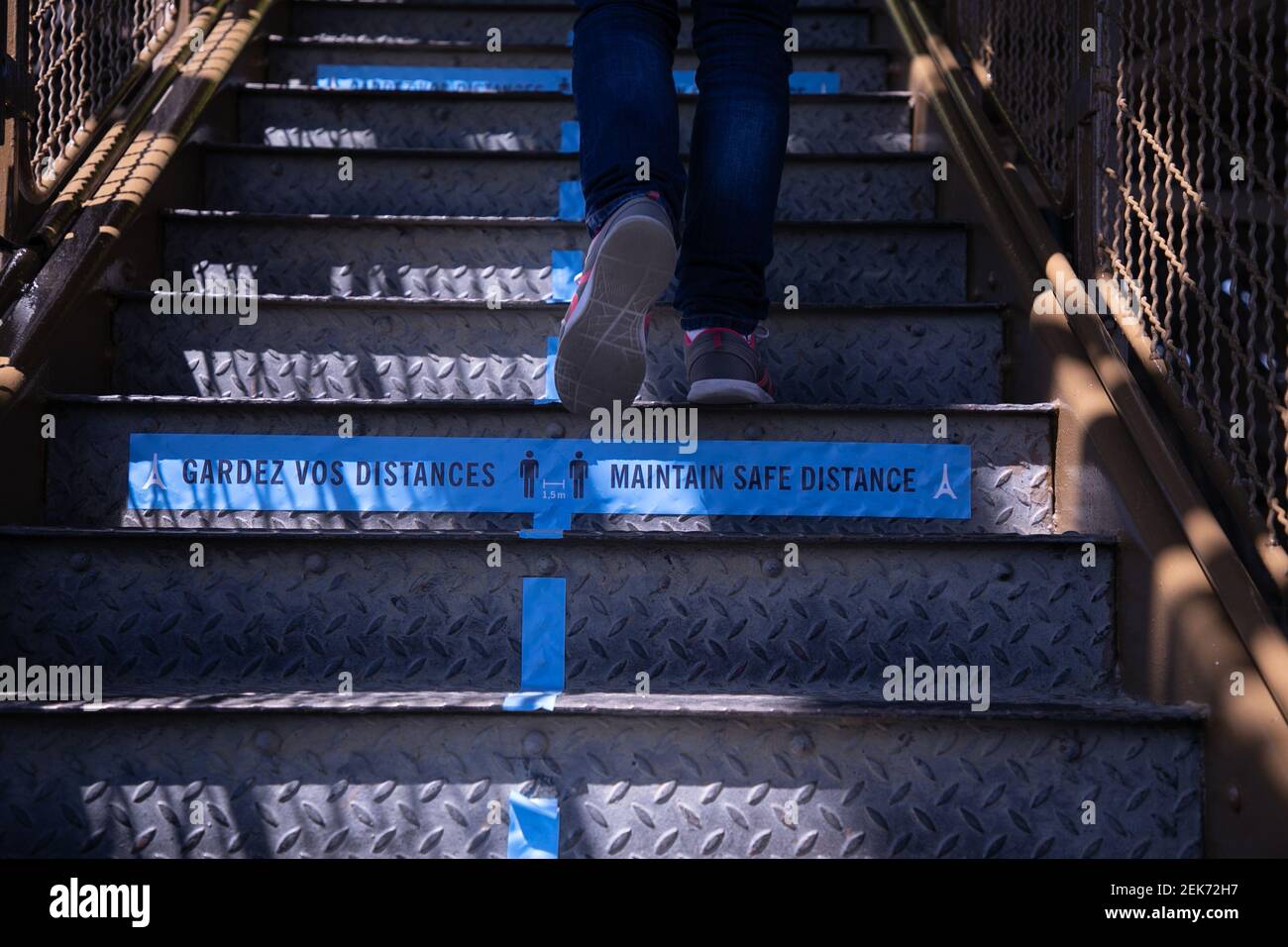 The stairs of the Eiffel Tower marked with social distancing signs as a ...