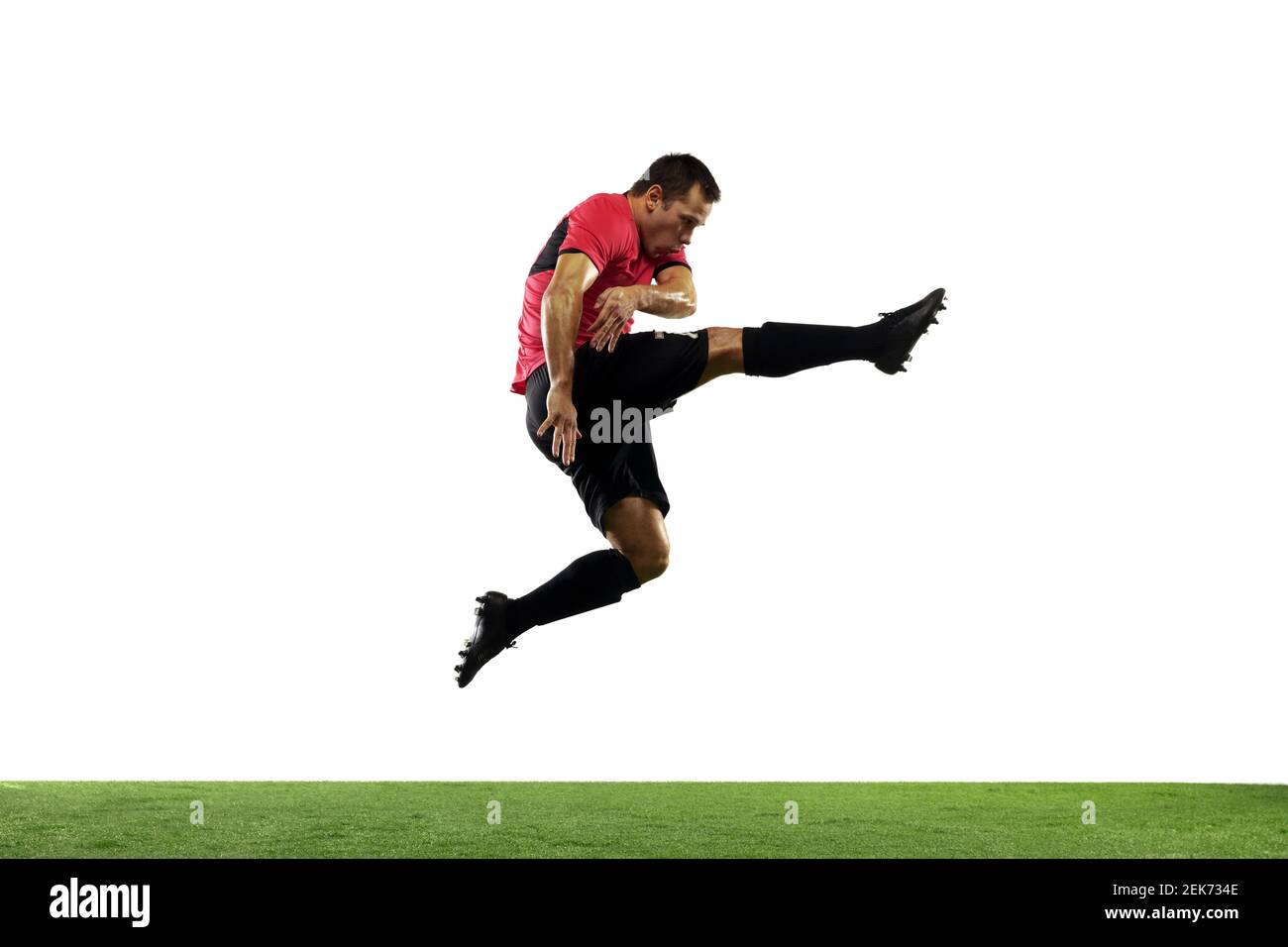Powerful, flying above the field. Young football, soccer player in ...