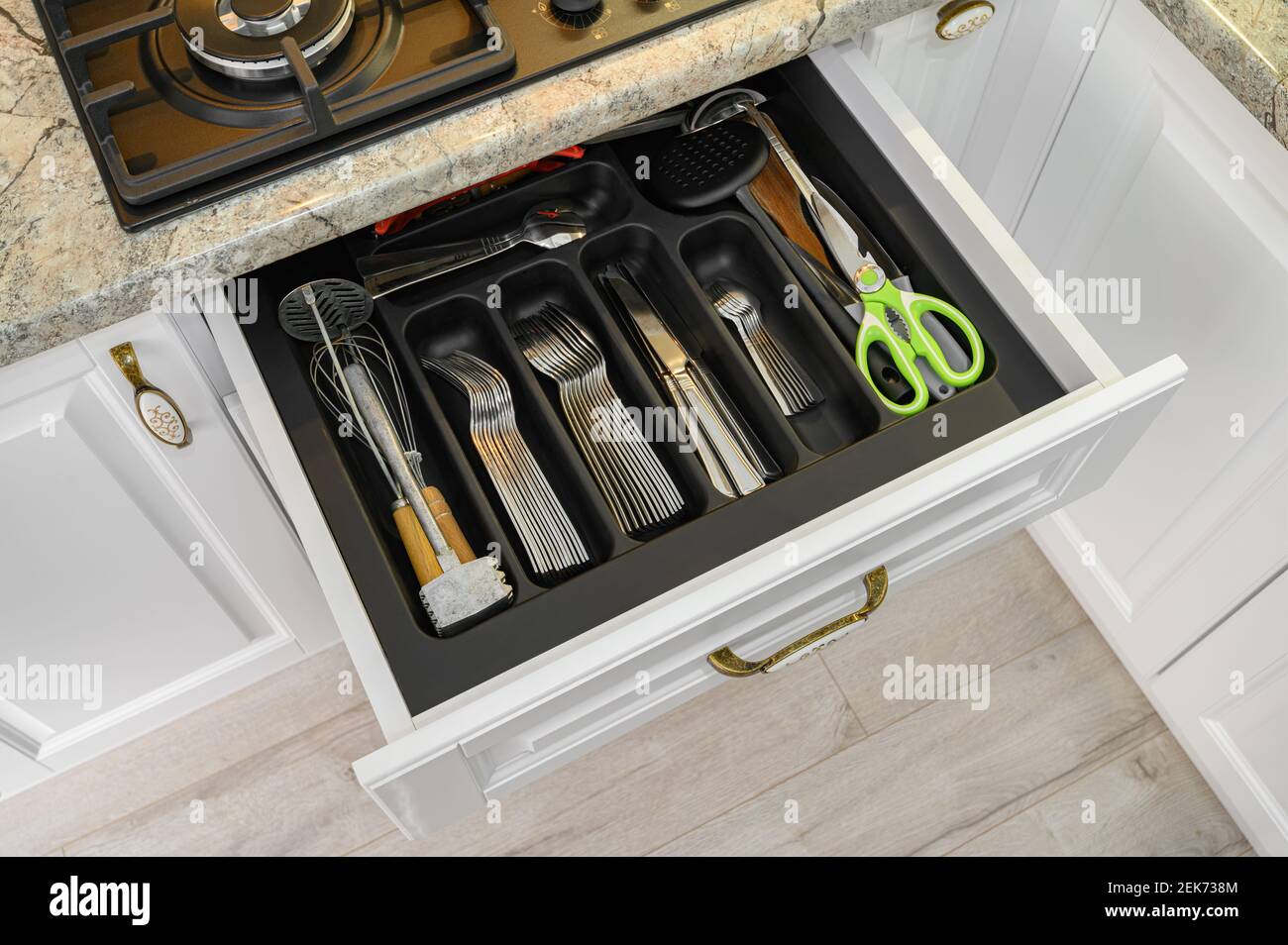 Drawers pulled out at modern classic white kitchen furniture Stock ...