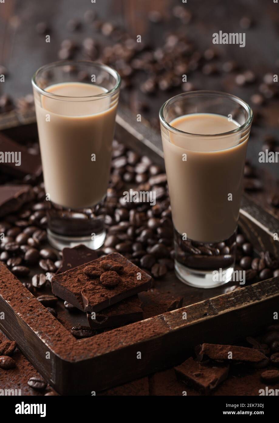 Irish cream baileys liqueur in shot glasses in wooden tray with coffee ...