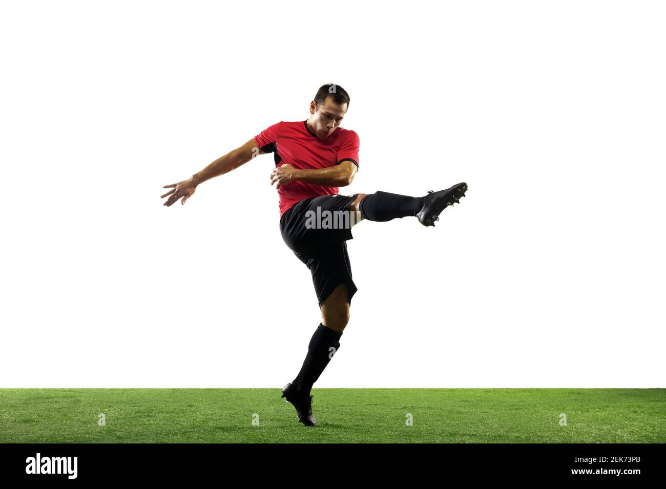 Powerful, flying above the field. Young football, soccer player in ...