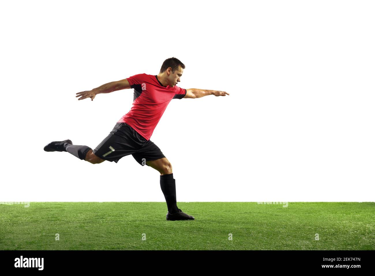 Powerful, flying above the field. Young football, soccer player in ...