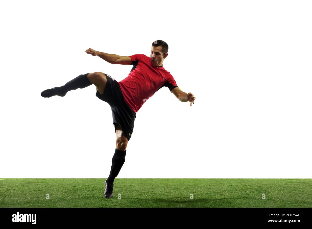 Powerful, flying above the field. Young football, soccer player in ...