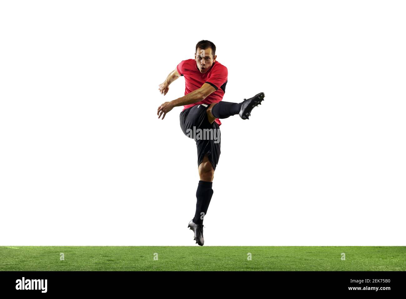 Powerful, flying above the field. Young football, soccer player in ...