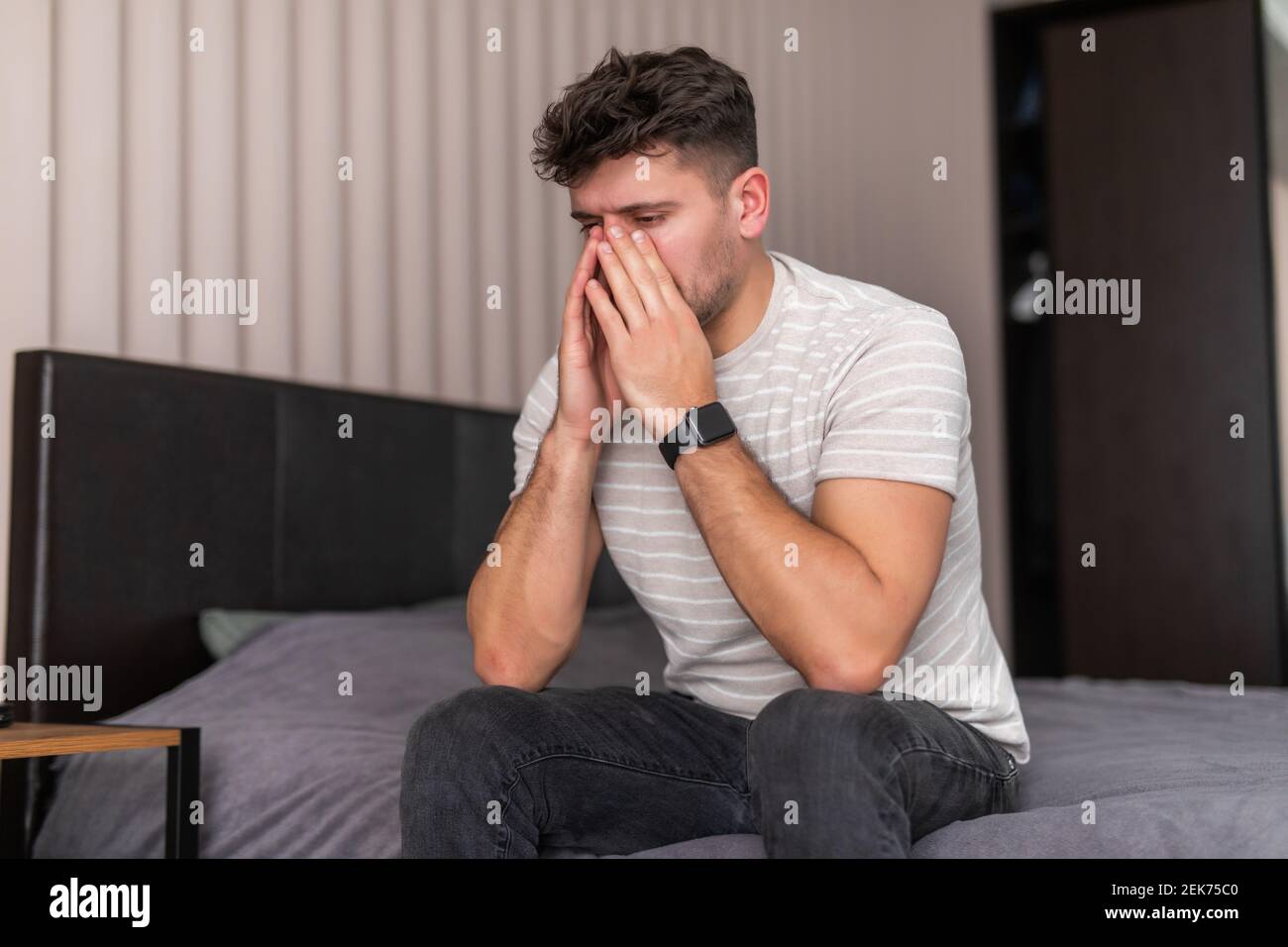 Man feeling bad lying in the bed and coughing Stock Photo - Alamy