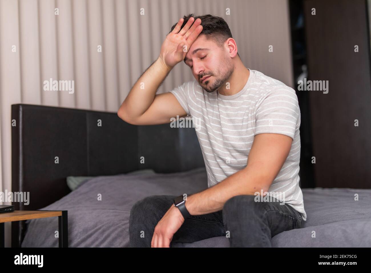 Man feeling bad lying in the bed and coughing Stock Photo - Alamy
