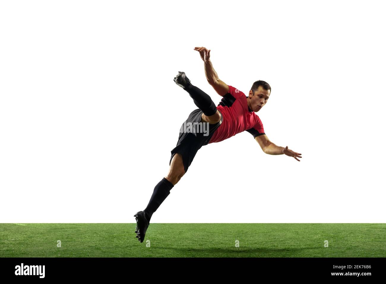 Powerful, flying above the field. Young football, soccer player in ...