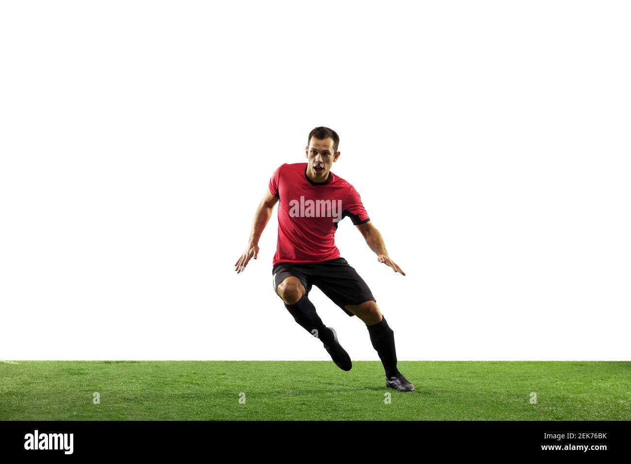 Powerful, flying above the field. Young football, soccer player in ...