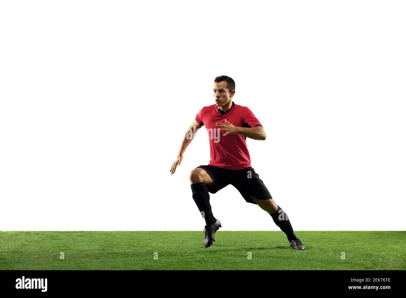 Powerful, flying above the field. Young football, soccer player in ...