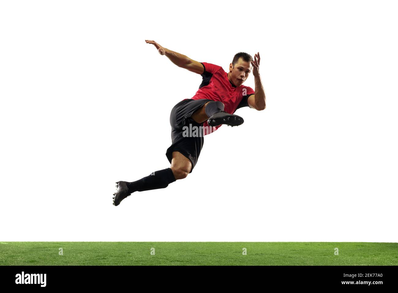 Powerful, flying above the field. Young football, soccer player in ...