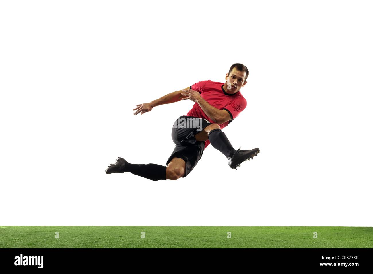 Powerful, flying above the field. Young football, soccer player in ...
