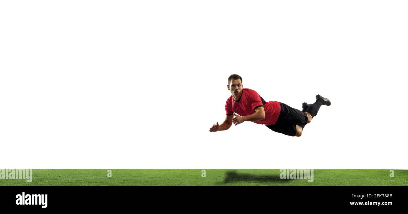 Powerful, flying above the field. Young football, soccer player in ...