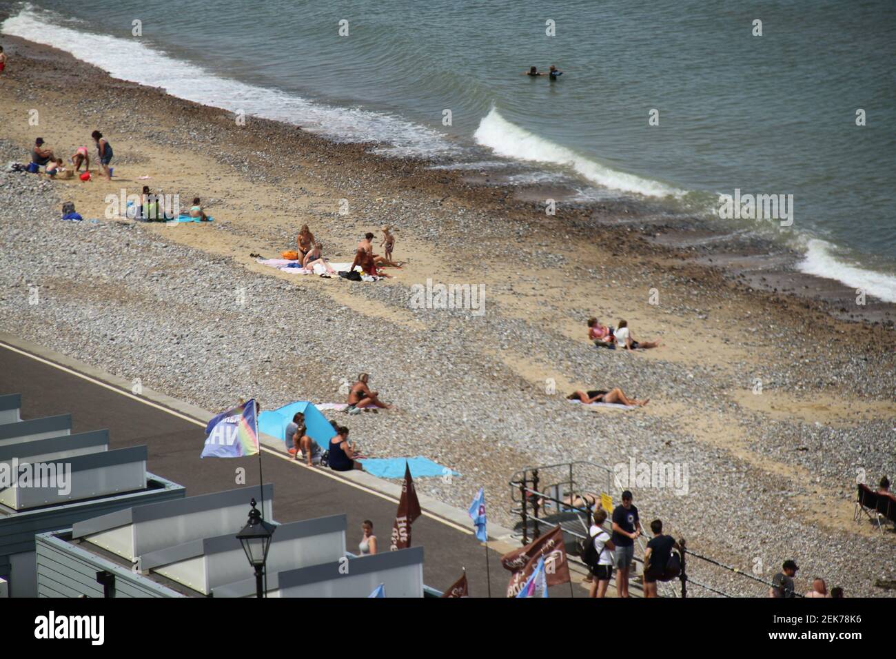 People sunbathing on the beach. People enjoy the hot sun on Cromer ...