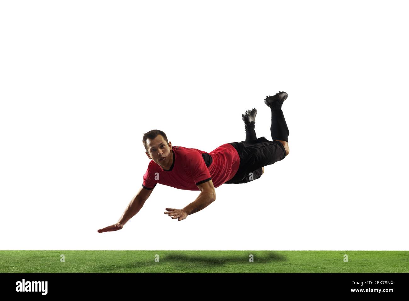 Powerful, flying above the field. Young football, soccer player in ...