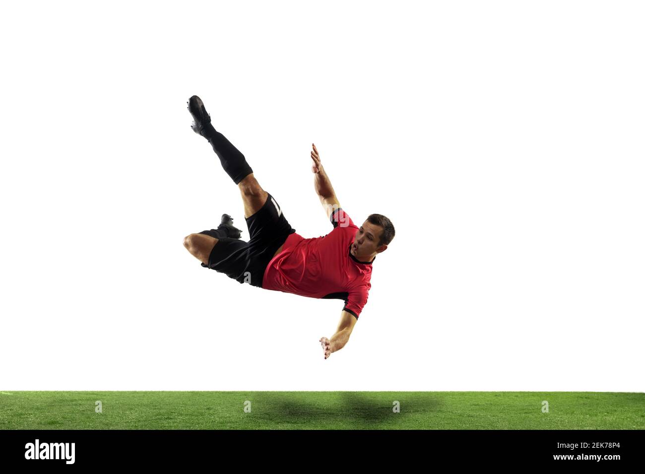 Powerful, flying above the field. Young football, soccer player in ...