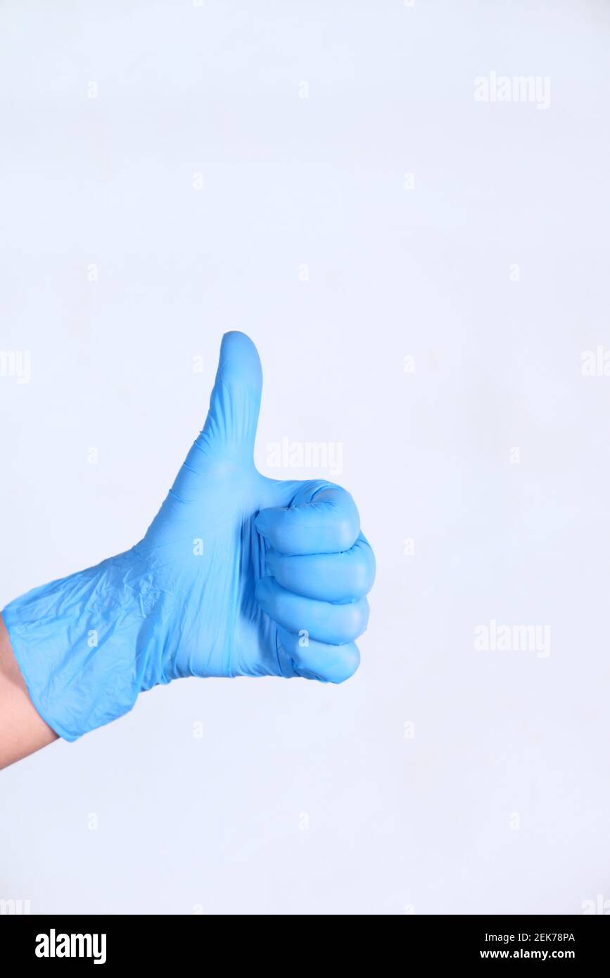hand in medical gloves showing a thumb-up on white background Stock ...