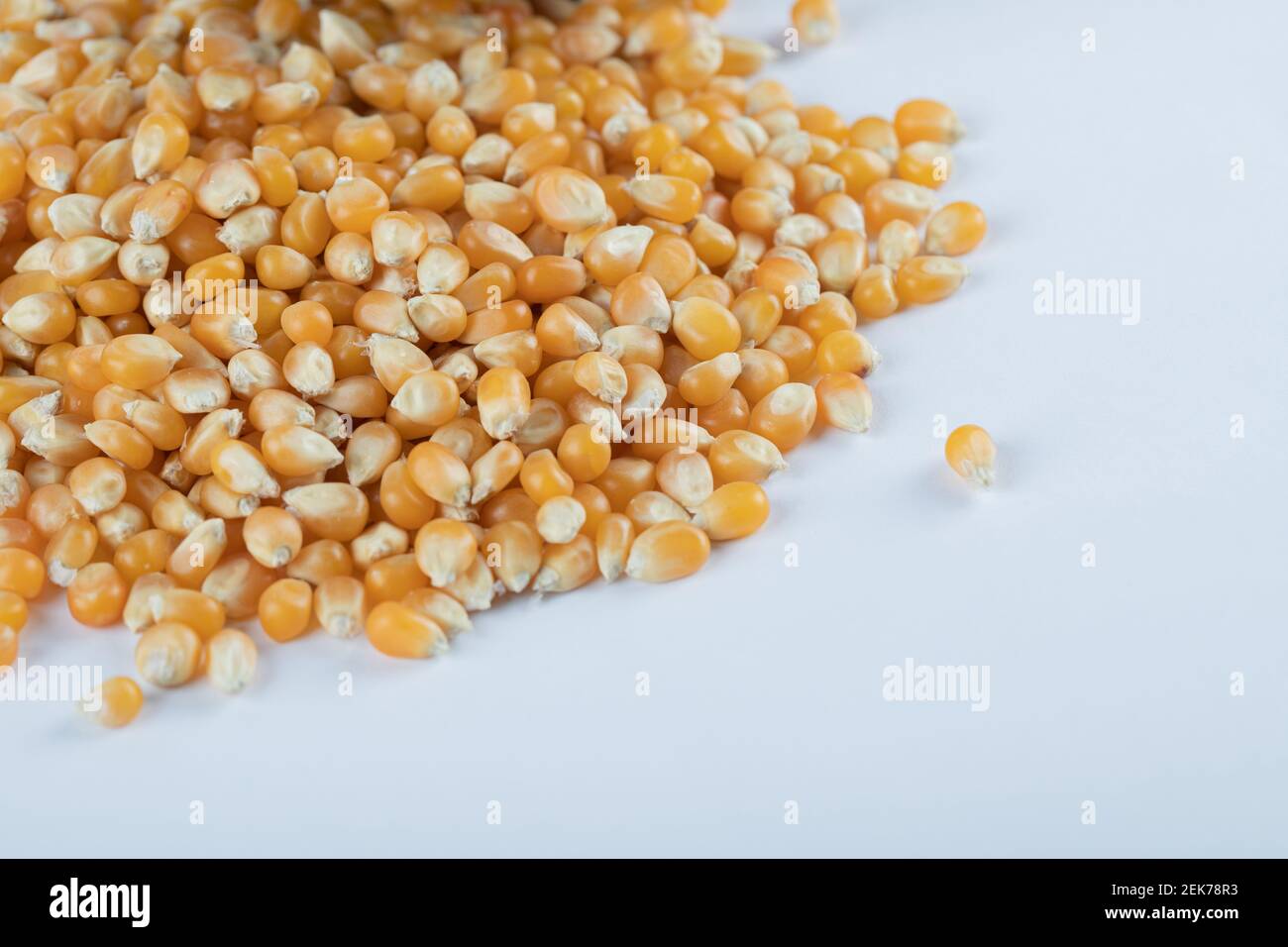 Heap of raw popcorn grains on white background Stock Photo - Alamy