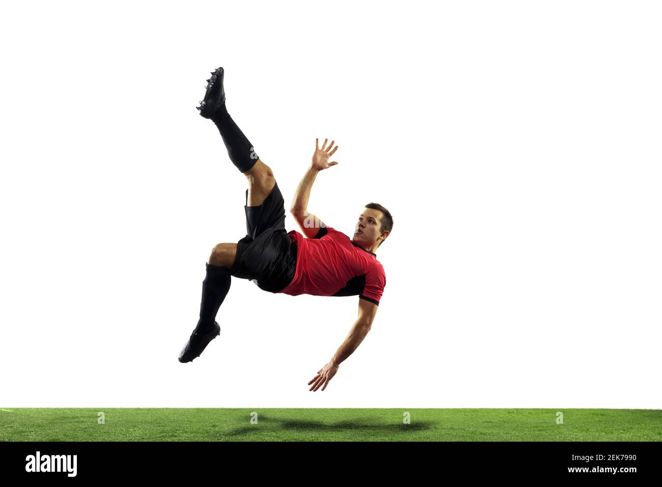 Powerful, flying above the field. Young football, soccer player in ...