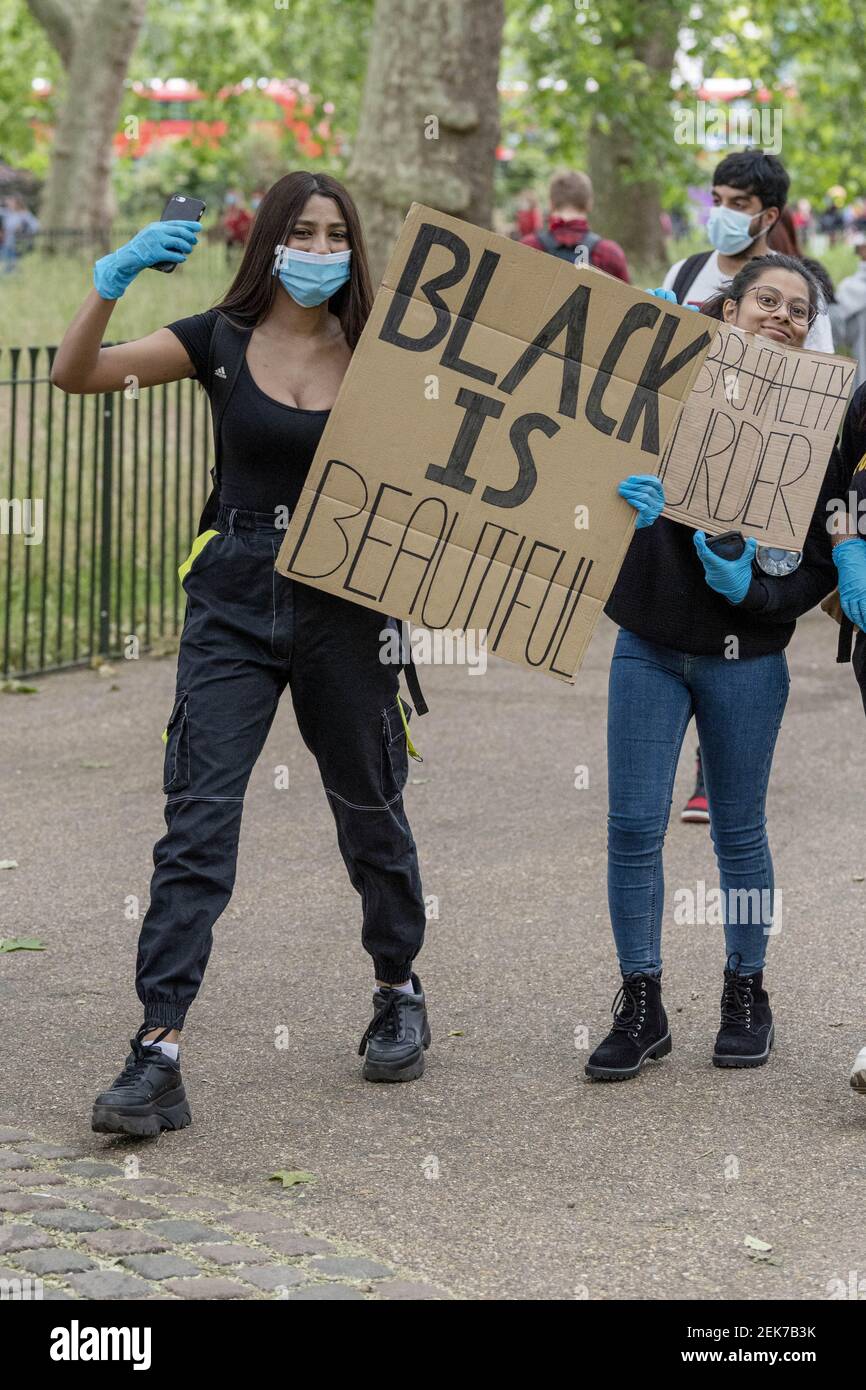 A protester holds a placard that says Black Is Beautiful during the ...