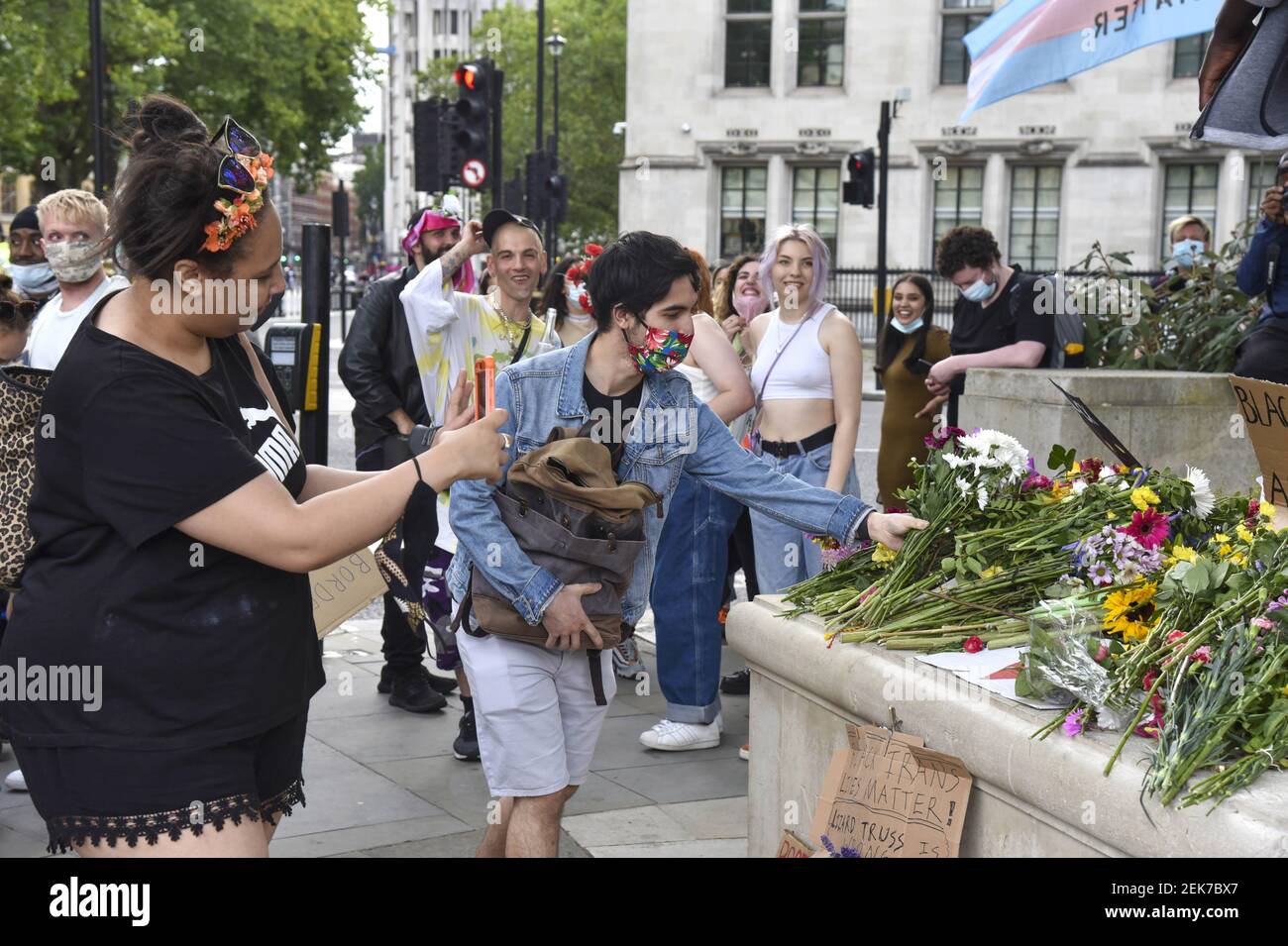 Protesters lay flowers at the foot of the Nelson Mandela statue in ...
