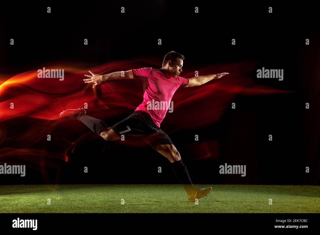 Powerful, flying above the field. Young football, soccer player in ...