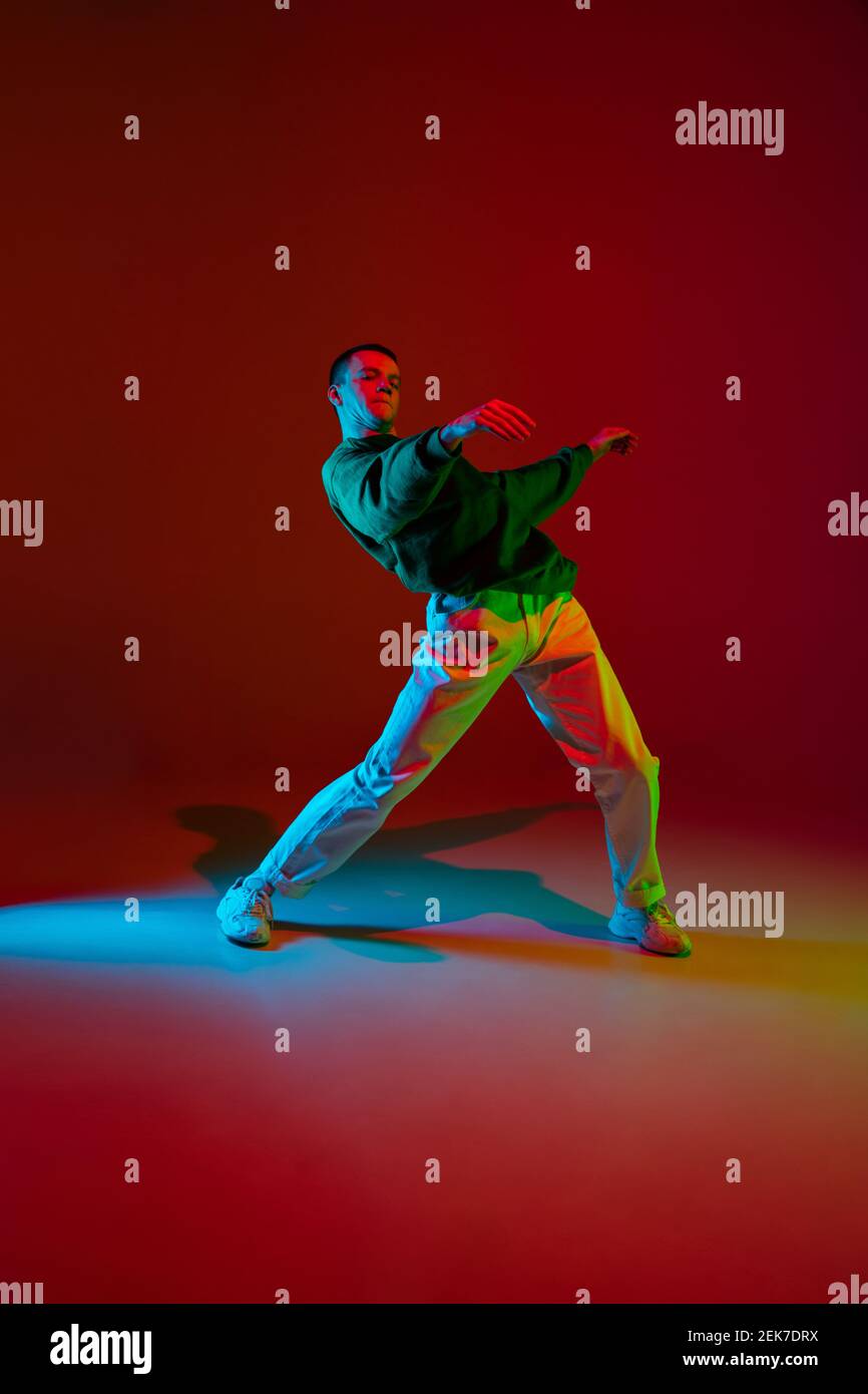 Freedom. Stylish sportive boy dancing hip-hop in stylish clothes on ...