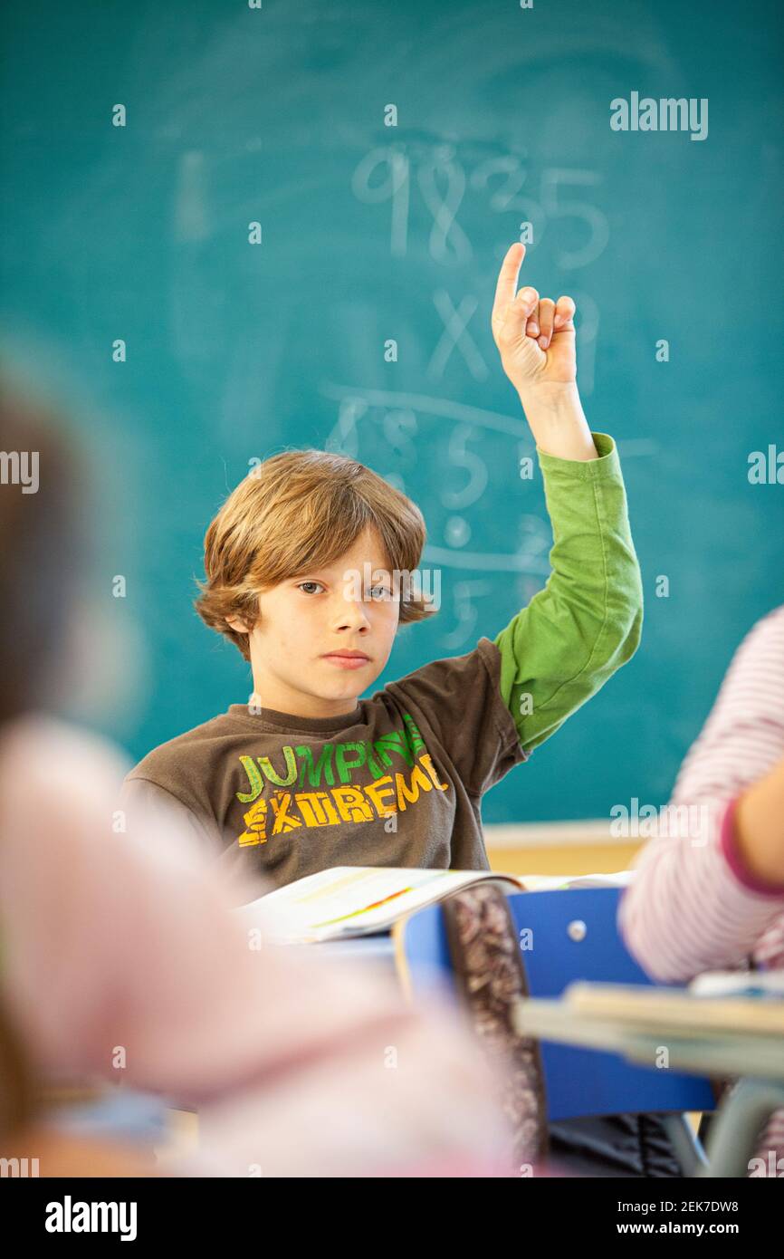 Young boy looking to camera in a school classroom Stock Photo - Alamy