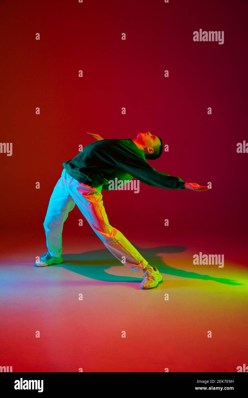 Freedom. Stylish sportive boy dancing hip-hop in stylish clothes on ...