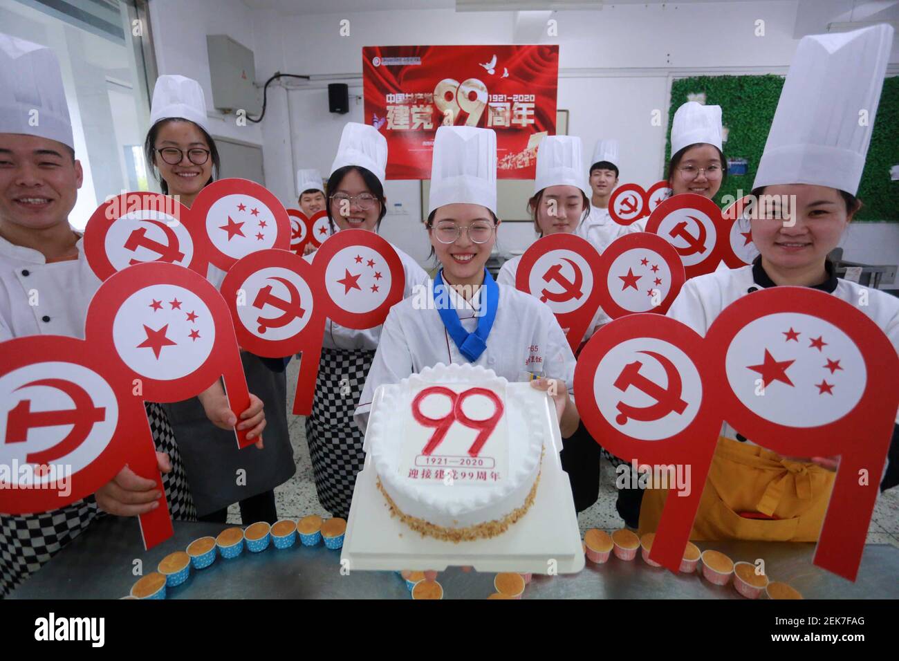 YANGZHOU, CHINA - JUNE 29, 2020 - A student displays a cake celebrating ...