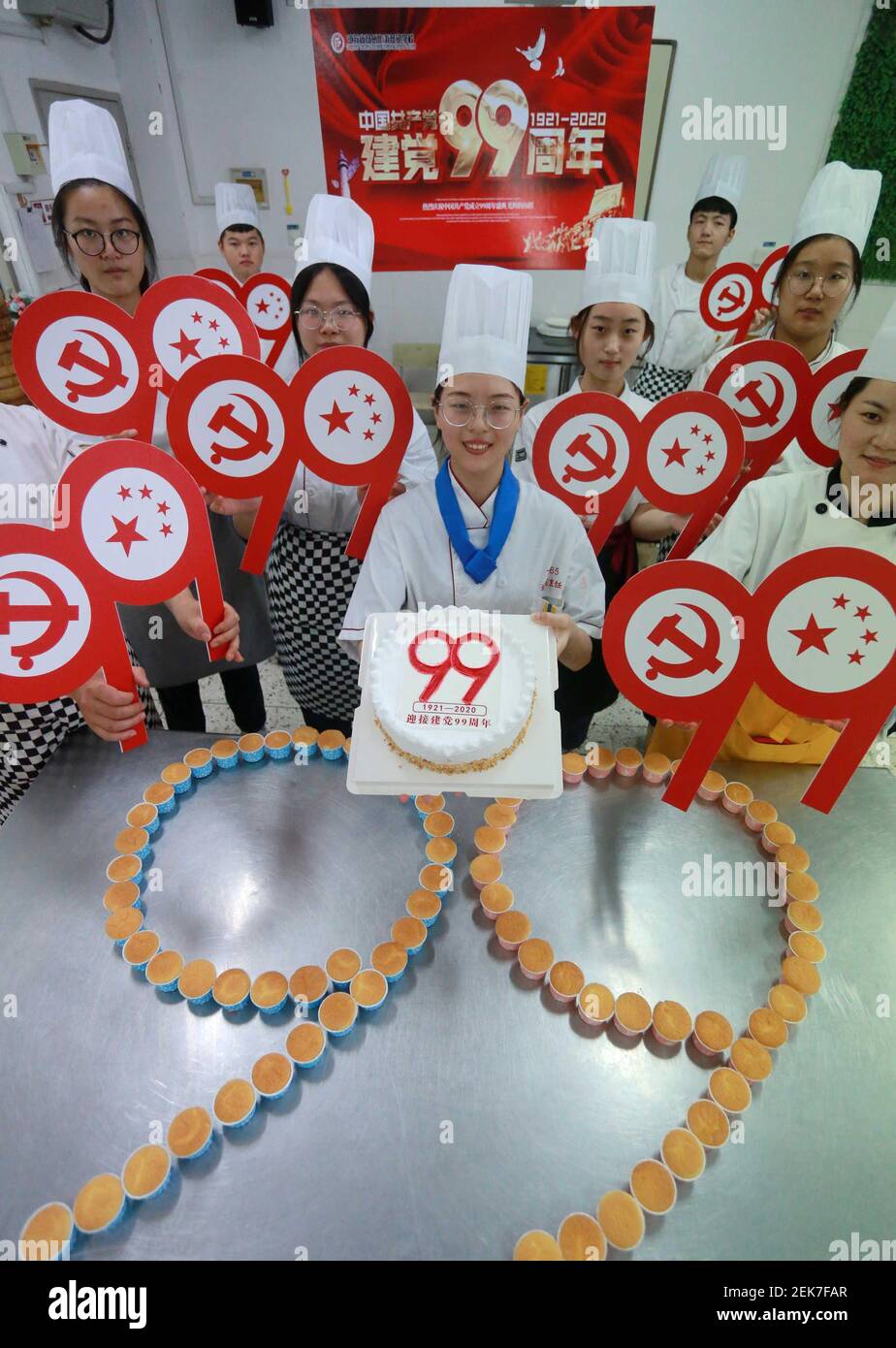 YANGZHOU, CHINA - JUNE 29, 2020 - A student displays a cake celebrating ...
