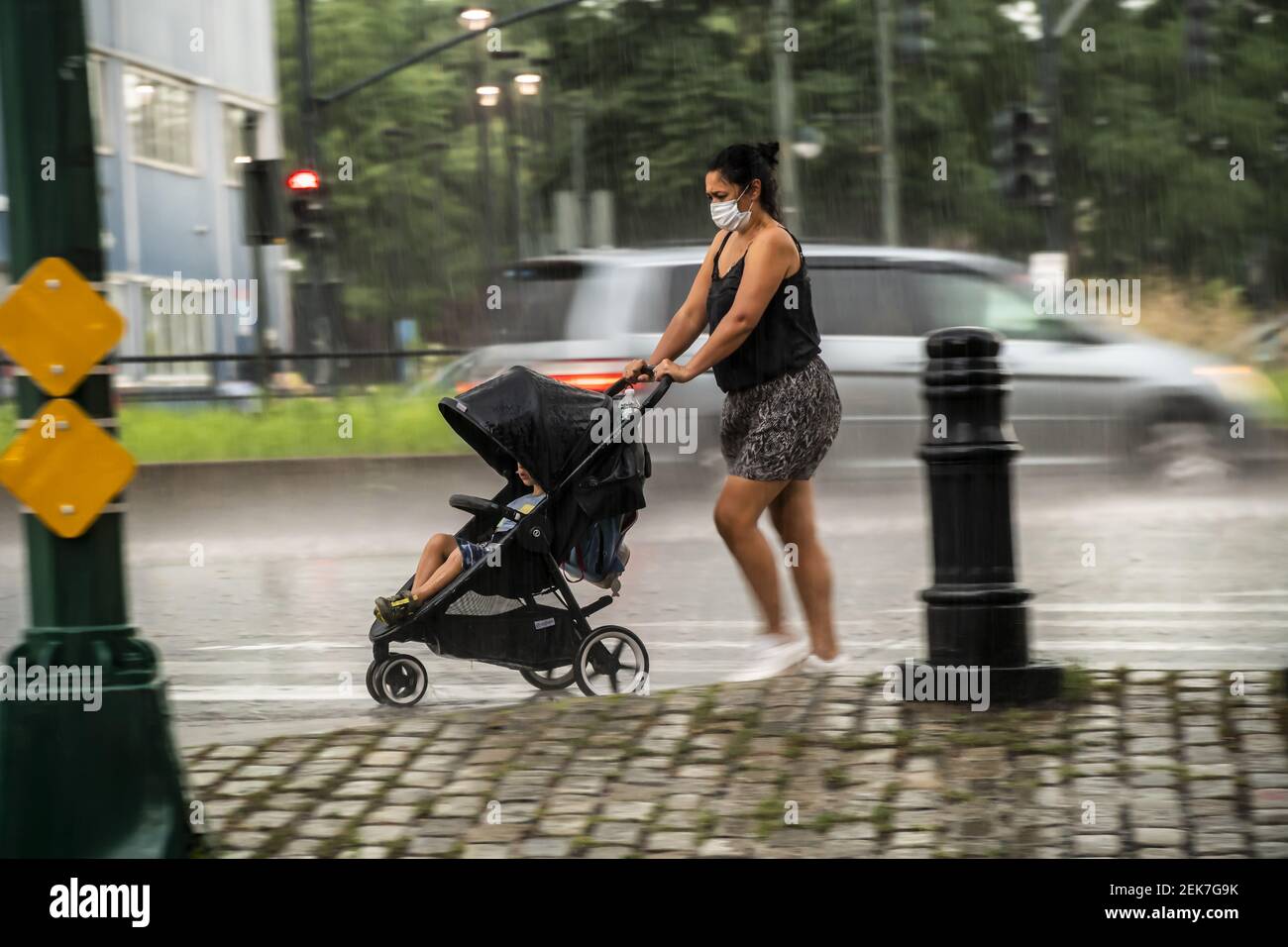Woman runs through the rainstorm in the Chelsea neighborhood of New ...