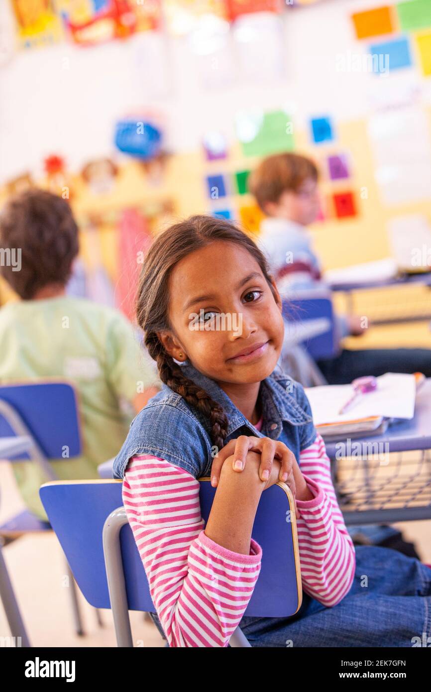 Young girl looking to camera in a school classroom Stock Photo - Alamy