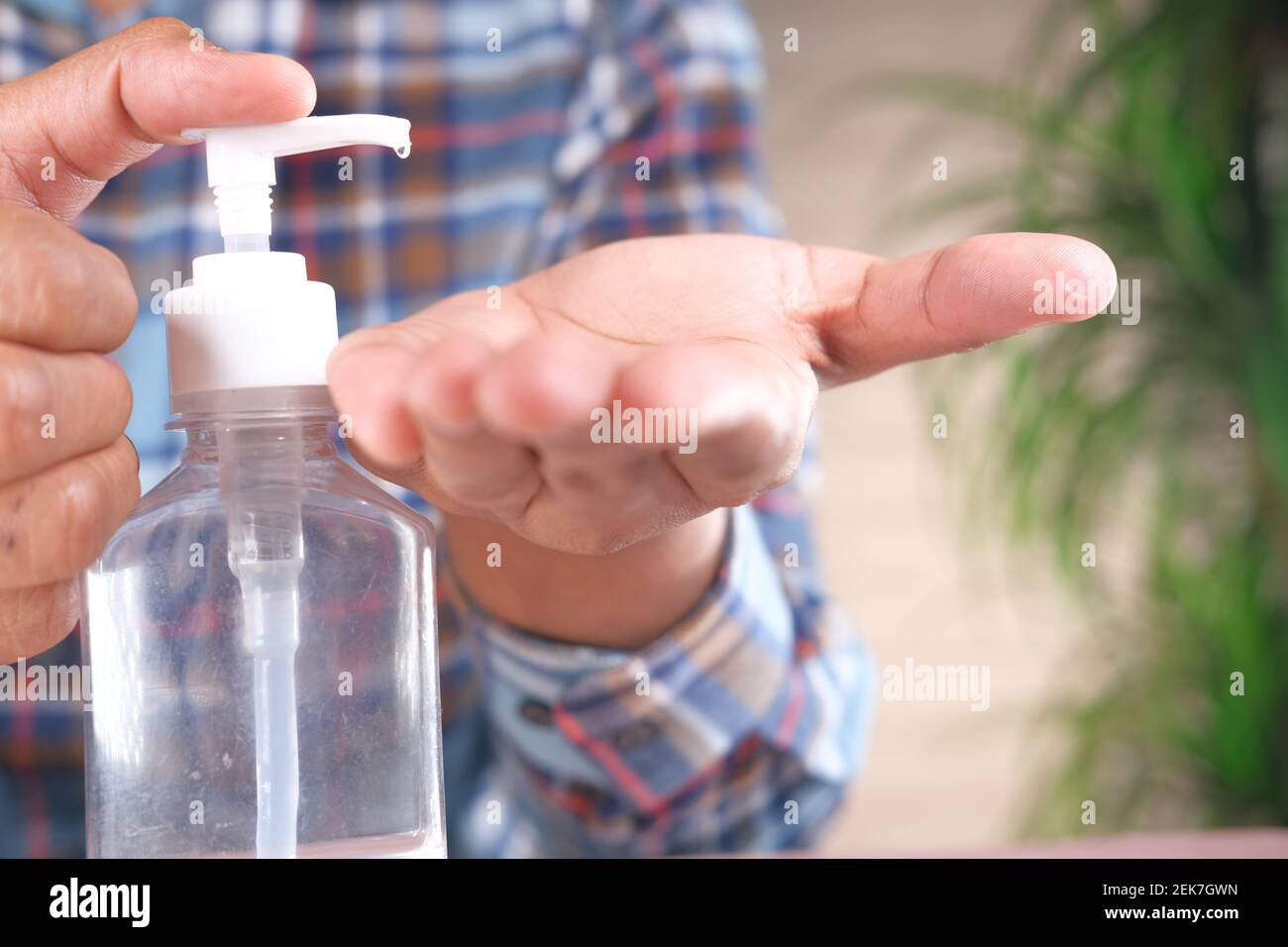 Using sanitizer liquid for preventing corona virus Stock Photo - Alamy