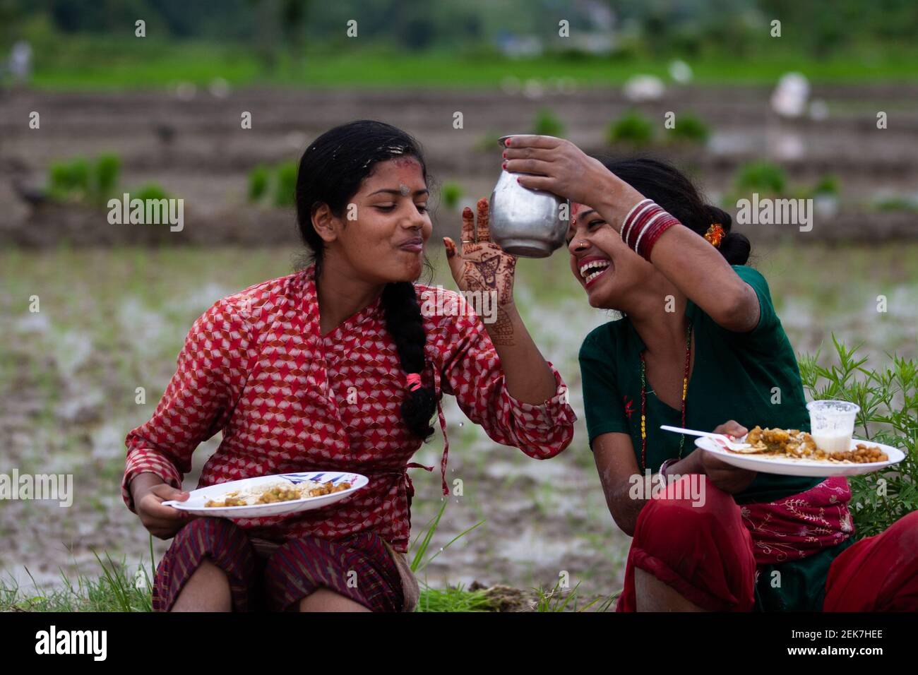 Farmers take a lunch break at a paddy field during the National Paddy ...