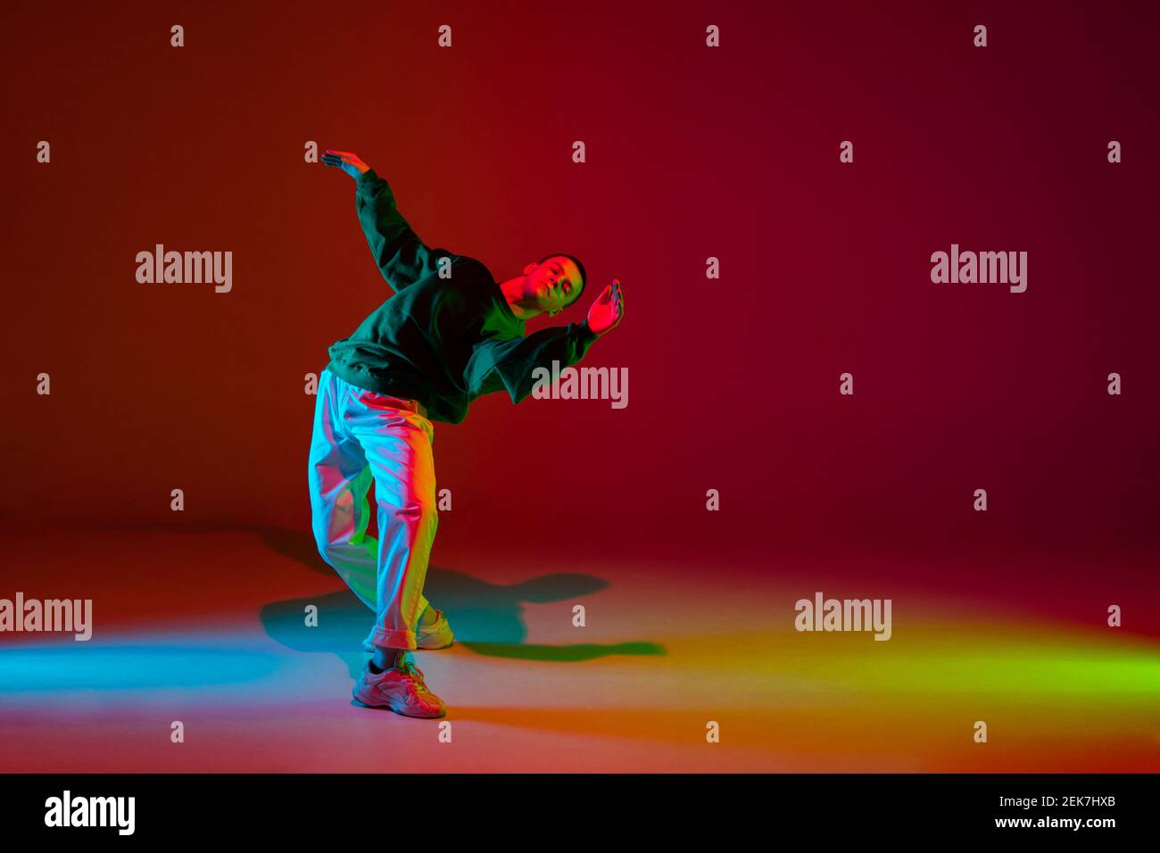 Style. Stylish sportive boy dancing hip-hop in stylish clothes on ...