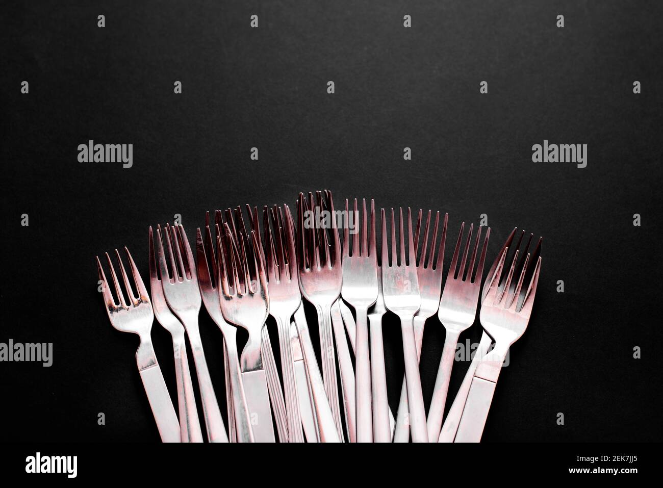 Simple and modern design forks viewed from above on clean black ...