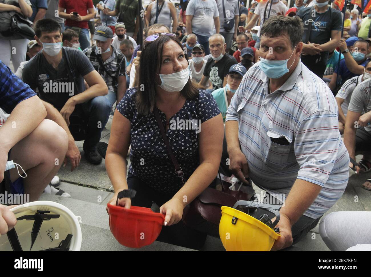 Miners hit their helmets on the ground during the demonstration. Miners ...