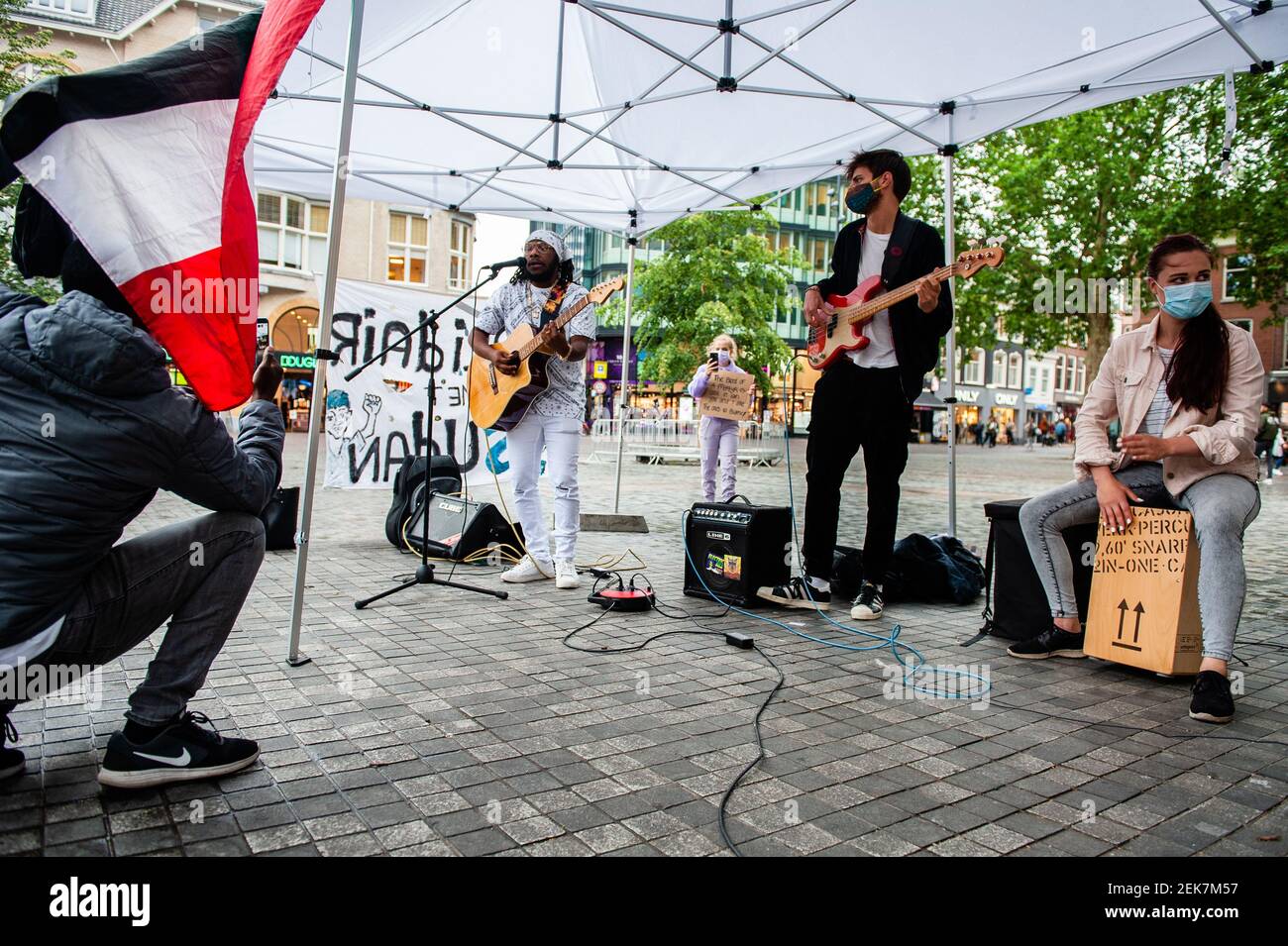 A man takes a photo of the Sudanese band with his mobile phone during ...