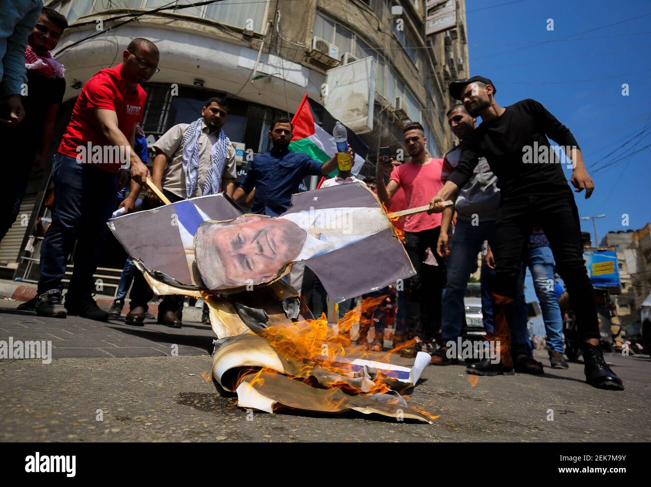 Palestinian demonstrators burn posters depicting the faces of U.S ...