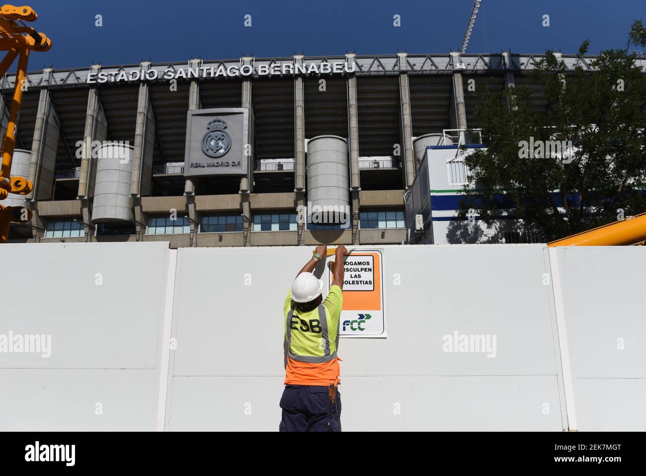 A worker is seen putting up a sign as renovation works continue at ...