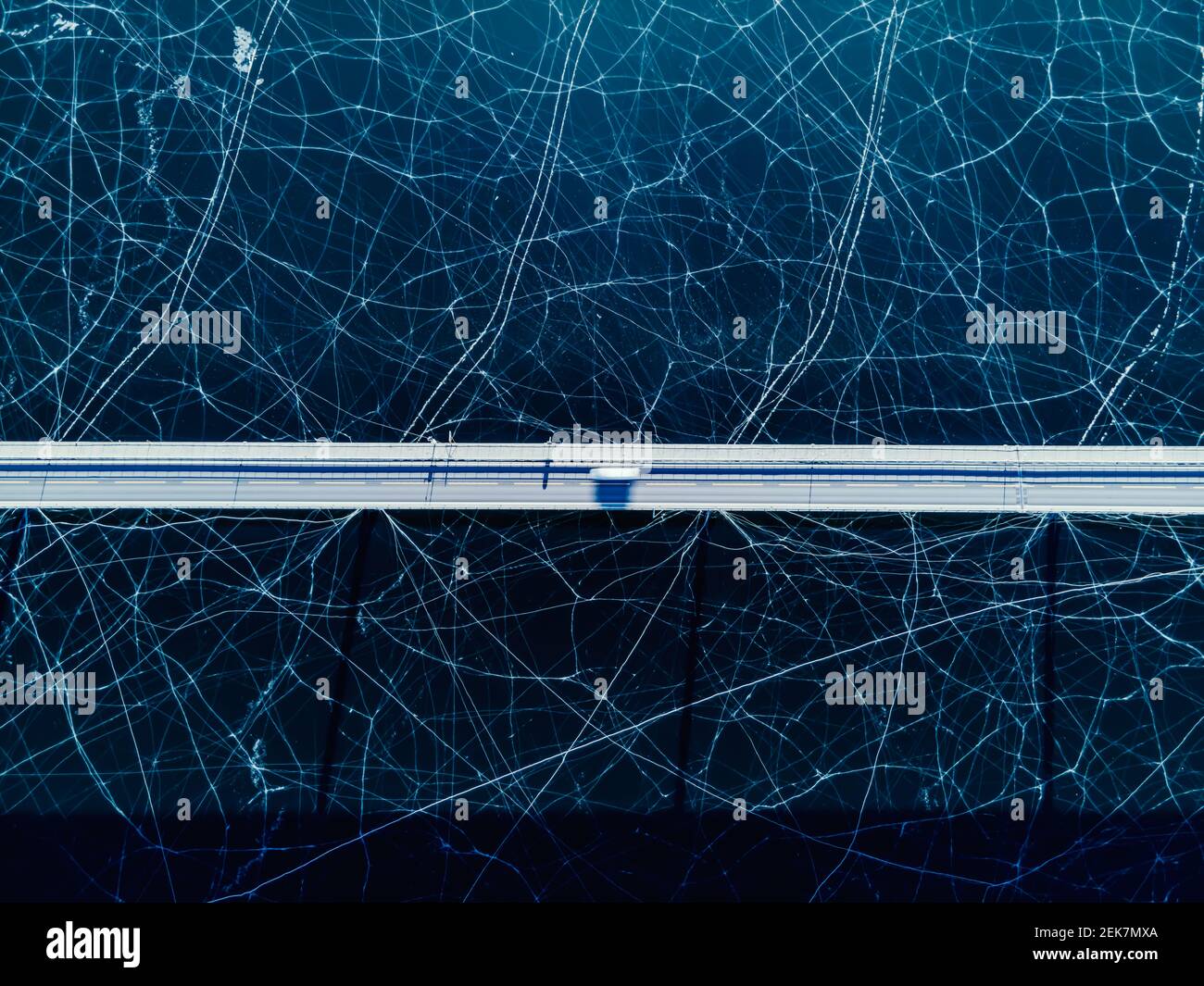 Top down view of a highway bridge spanning over a frozen lake Stock ...