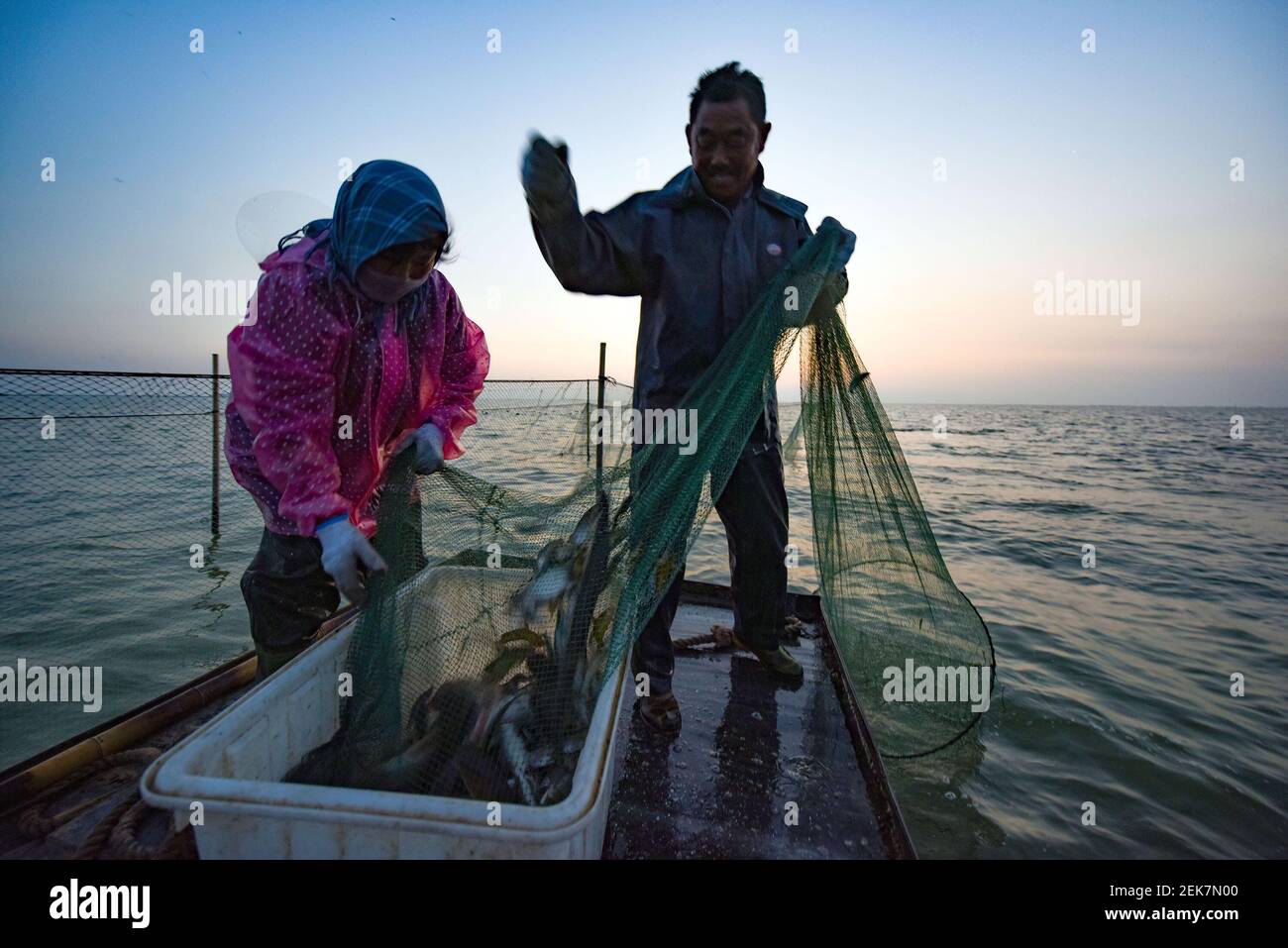 SIQIAN, CHINA - JULY 1, 2020 - Fishermen fish in Luoma Lake. Suqian ...