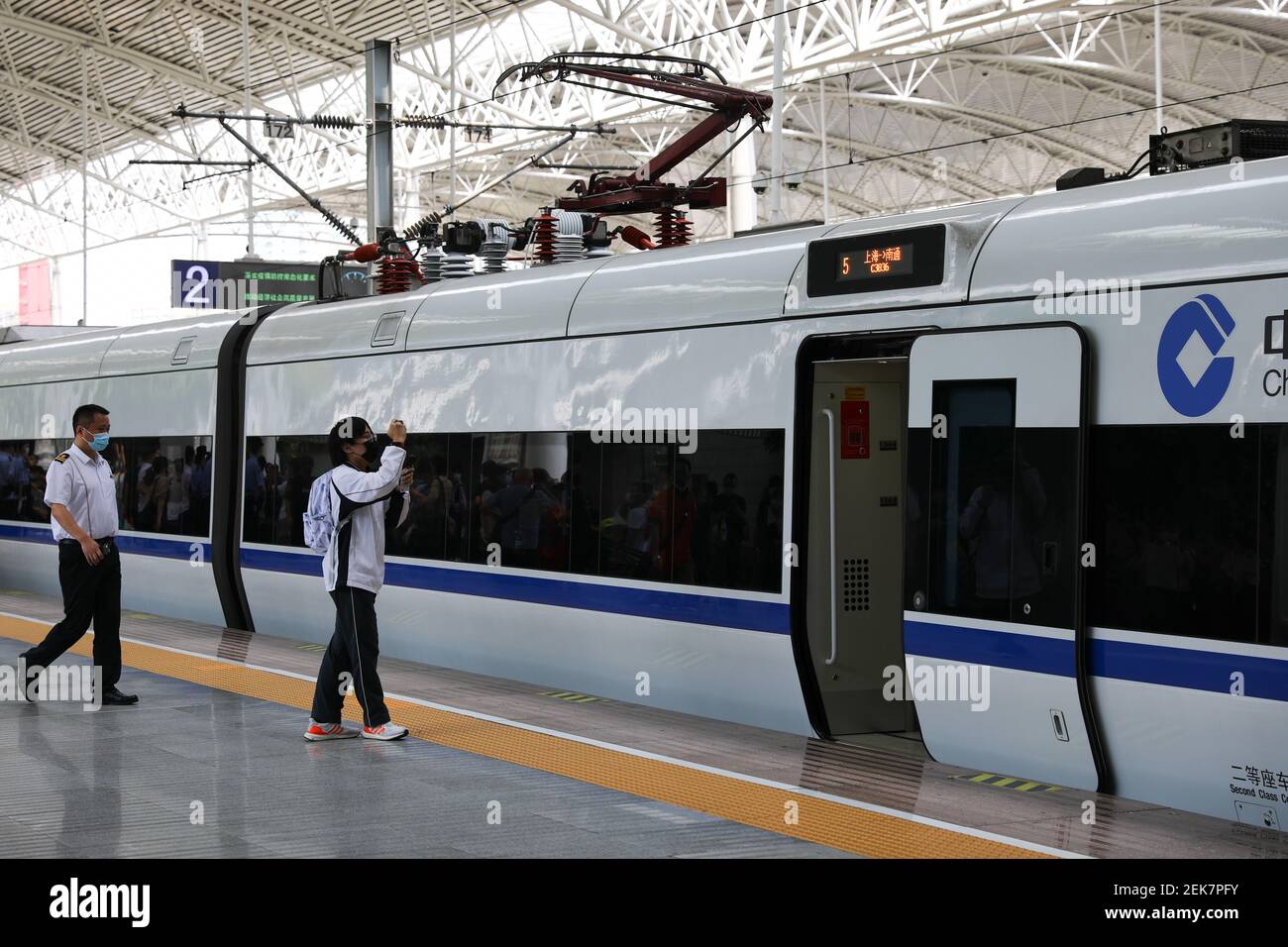 The train crew and travellers celebrate the opening of Shanghai-Suzhou ...