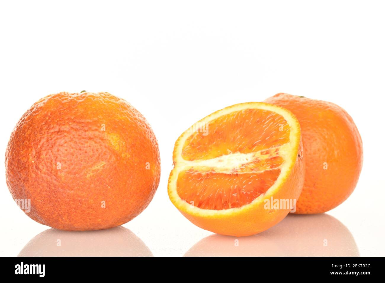 Two whole and one half organic ripe juicy red Sicilian orange on a ...