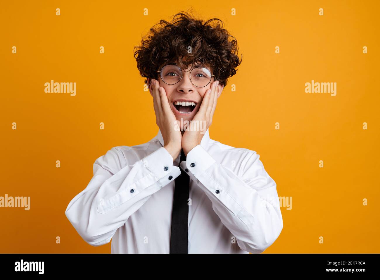 Happy excited male student standing wearing uniform isolated on a ...