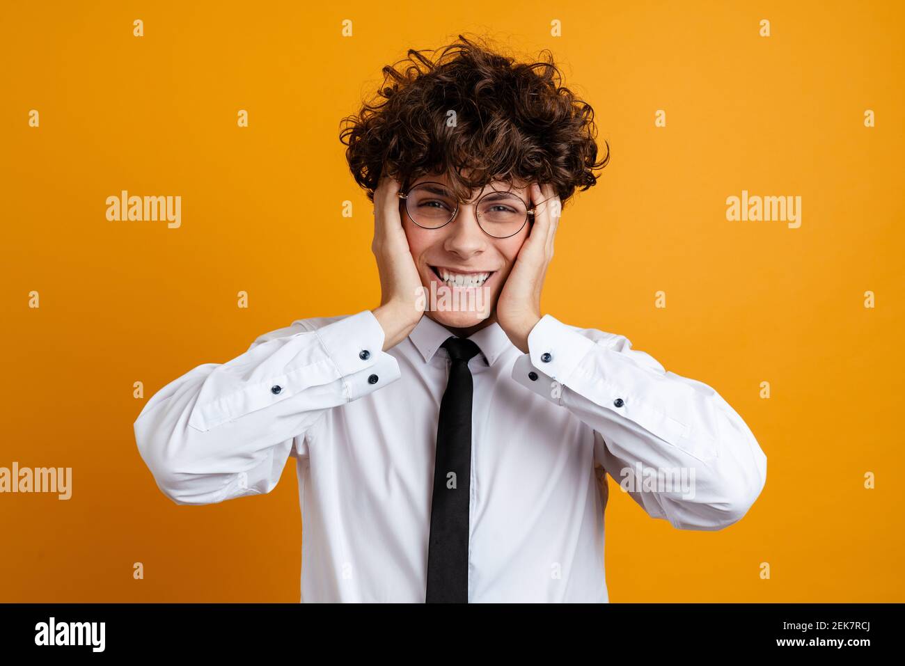 Happy excited male student standing wearing uniform isolated on a ...