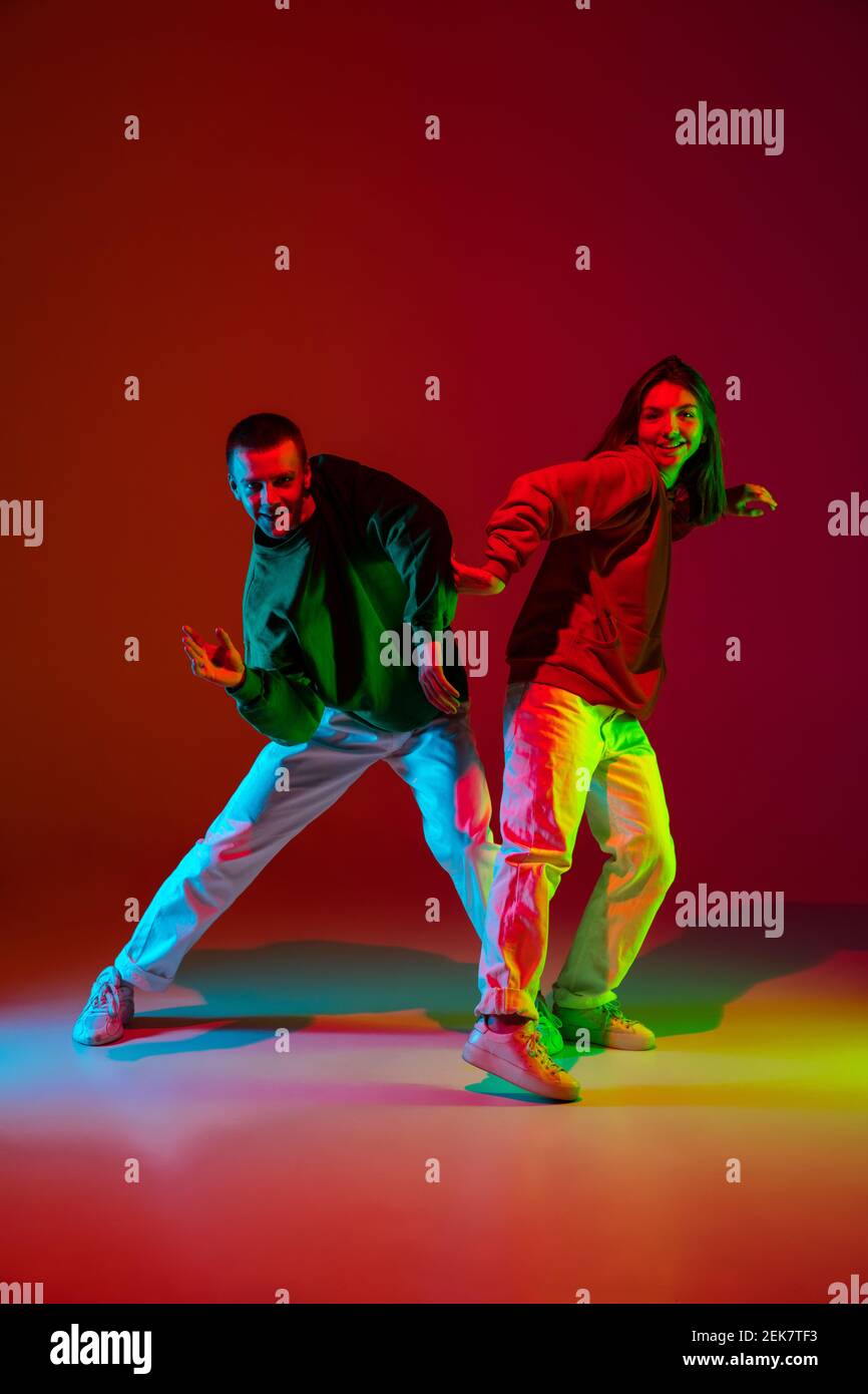 Urban. Stylish sportive couple dancing hip-hop in stylish clothes on ...