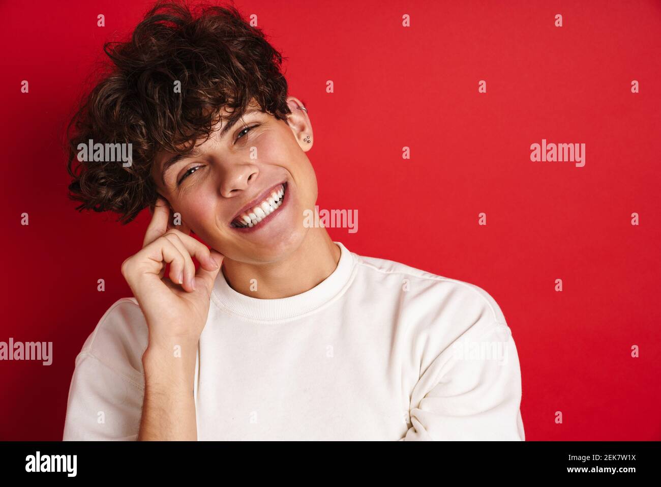 Handsome Cheerful Guy Smiling And Looking At Camera Isolated Over Red 2522
