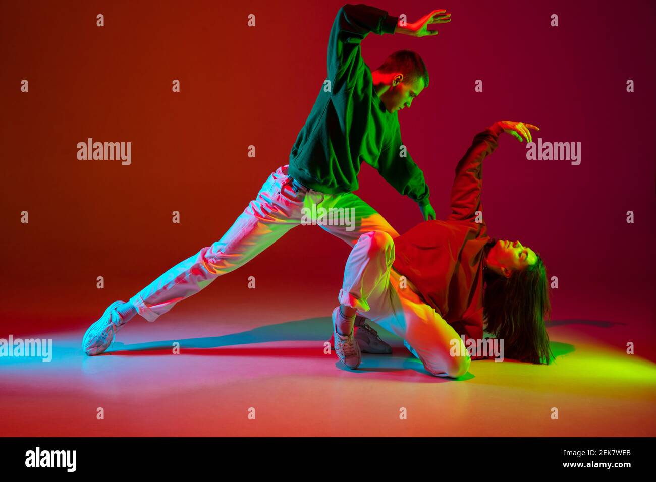 Emotions. Stylish sportive couple dancing hip-hop in stylish clothes on ...