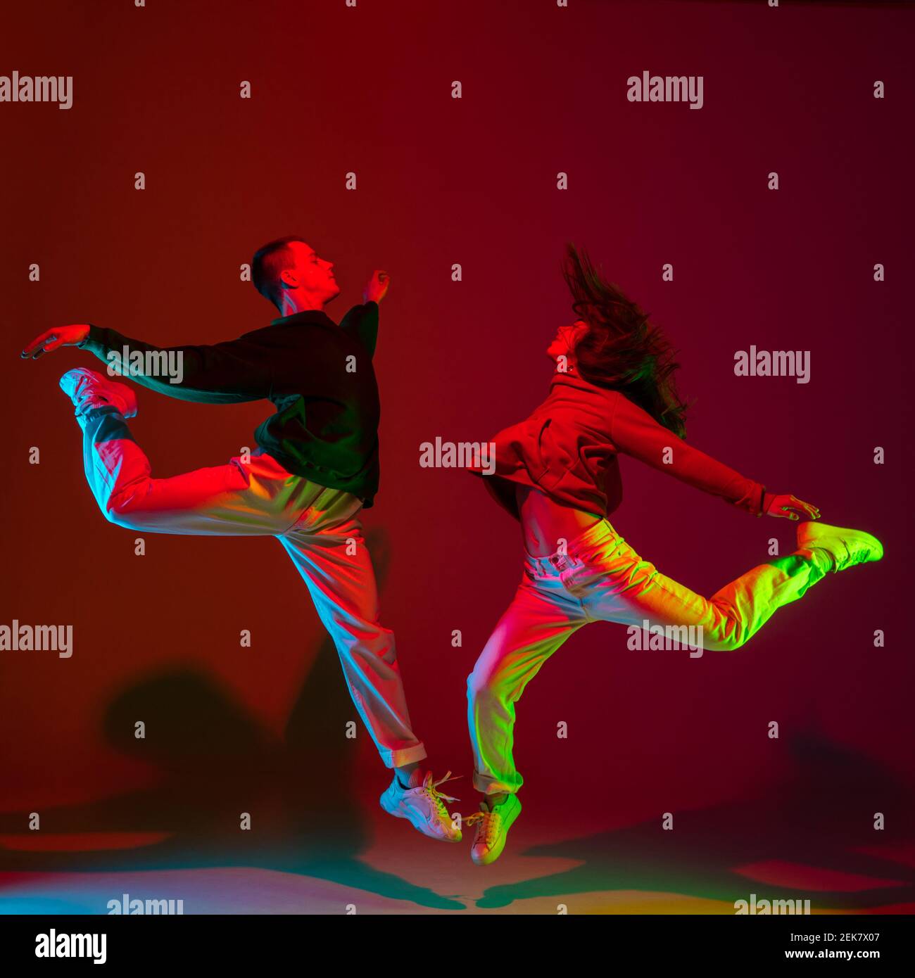 Flying. Stylish sportive couple dancing hip-hop in stylish clothes on ...